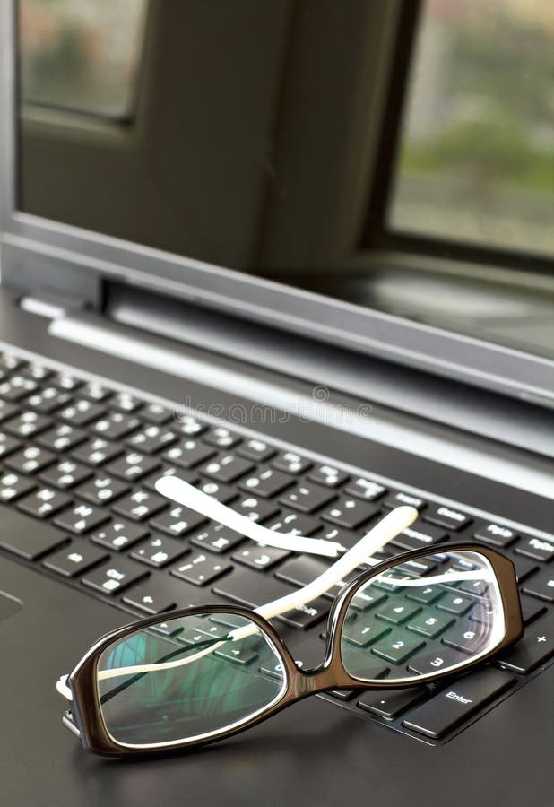 Glasses on laptop keyboard stock photo. Image of device - 71094212