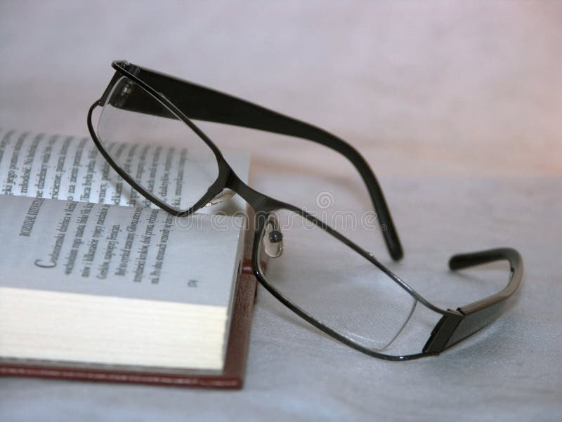 Glasses laying on a book stock image. Image of reading - 930909