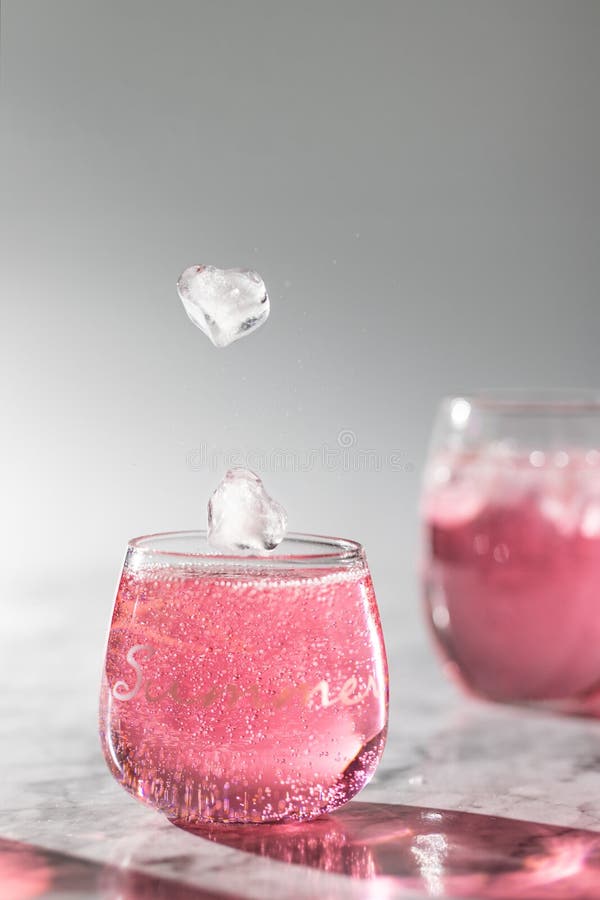 The Glasses Og Pink Drink and Ice Falling into Glass Stock Photo ...