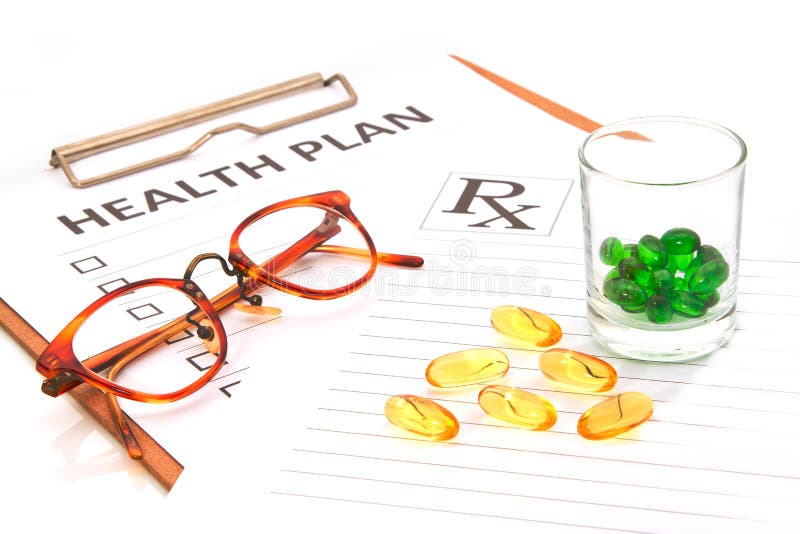 Glasses and Pill Capsules Resting on Health Plan Notes Stock Photo ...