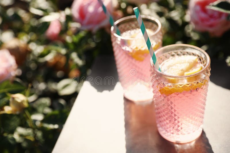 Glasses of Pink Rose Lemonade on Table in Blooming Garden Stock Image ...