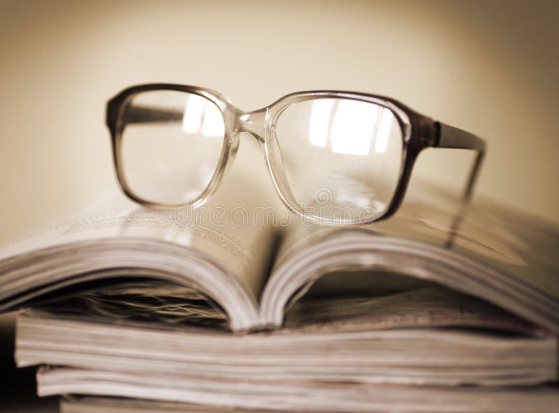Glasses for Reading on a Stack of Magazines, in Soft Focus Stock Image ...