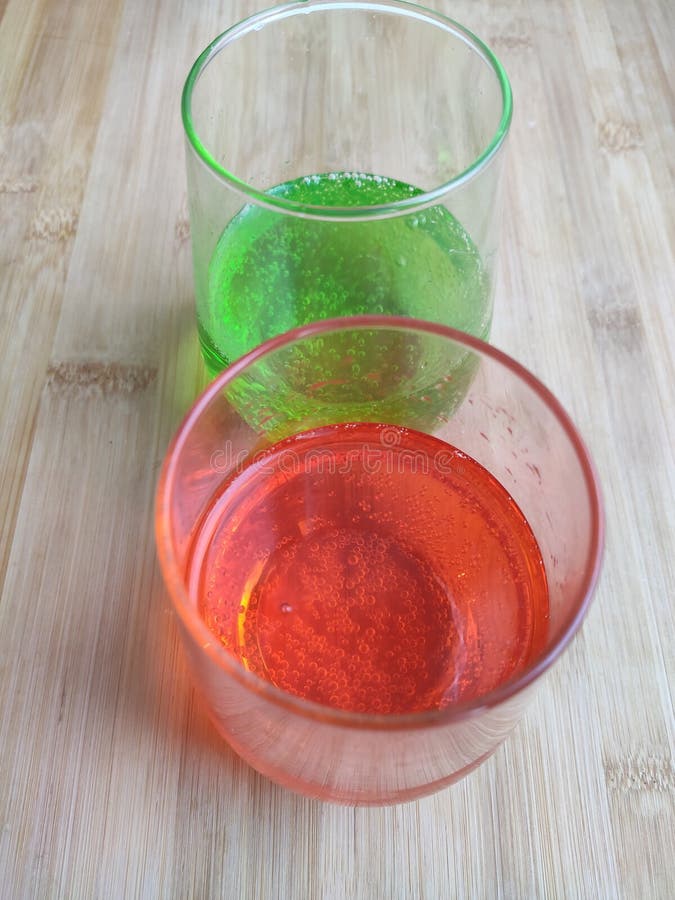 Glasses of Red and Green Sparkling Water on the Table Stock Image ...