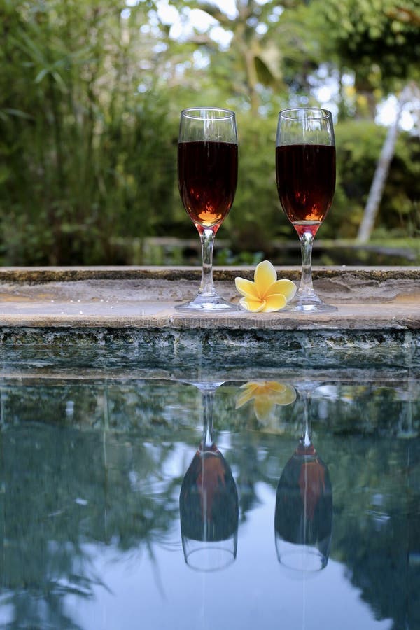 Glasses with Red Wine Near the Swimming Pool in the Tropics Stock Photo ...