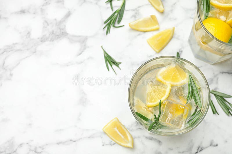 Glasses of Refreshing Lemonade on Marble Table, Space for Text. Summer ...