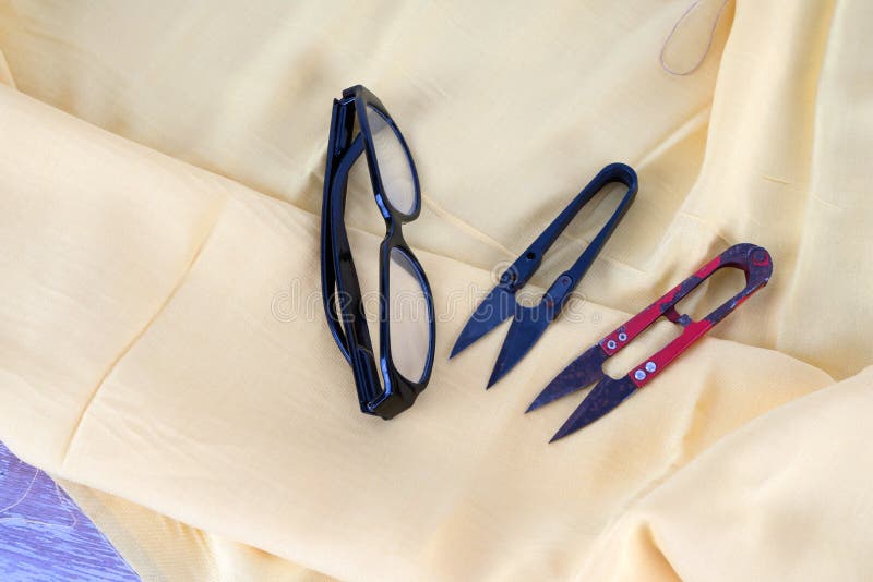 Glasses and Scissors on Yellow Cloth Stock Photo - Image of cloth ...