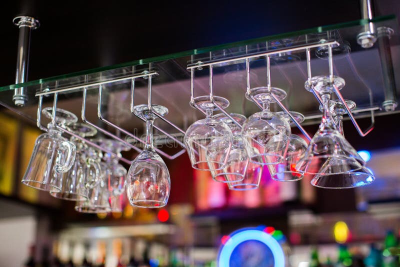 Glasses in Shelf Above a Bar Rack Stock Photo - Image of local ...