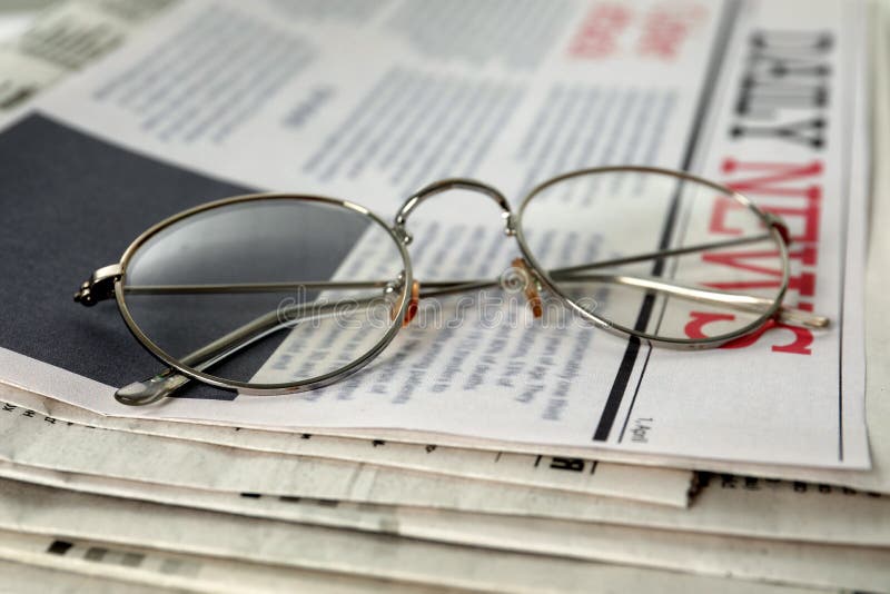 Glasses on Stack of Newspapers, Closeup View Stock Image - Image of ...