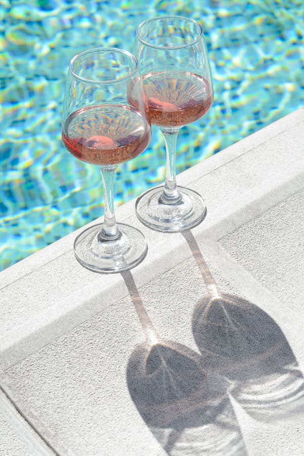 Glasses of Tasty Rose Wine on Swimming Pool Edge Stock Image - Image of ...