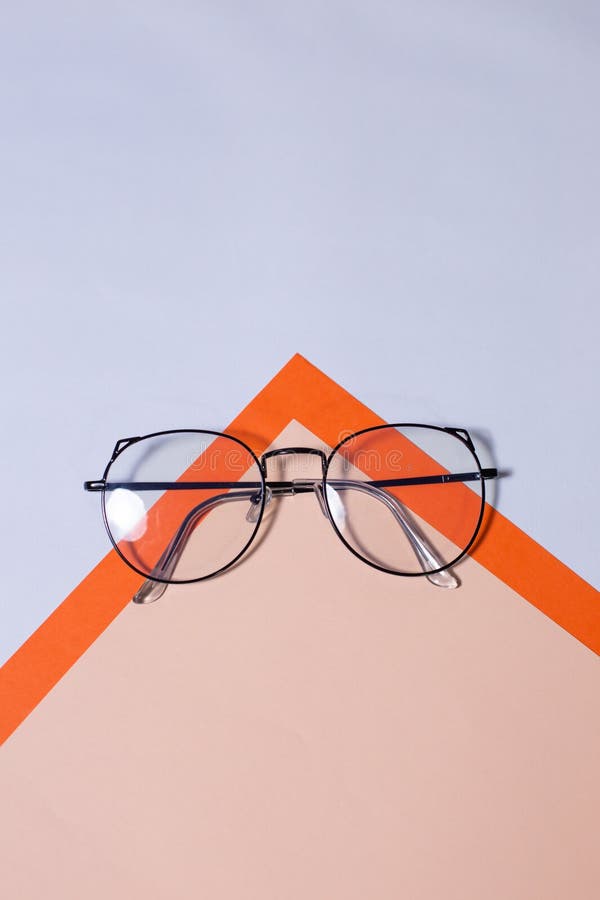 Glasses in a Thin Frame on a Background of Three Colors, Orange, Blue ...