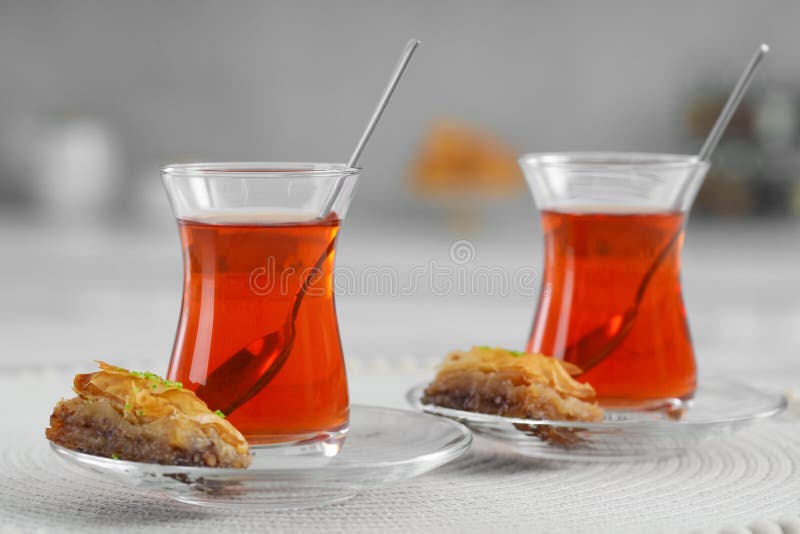 Glasses of Traditional Turkish Tea and Delicious Baklava on White Table ...