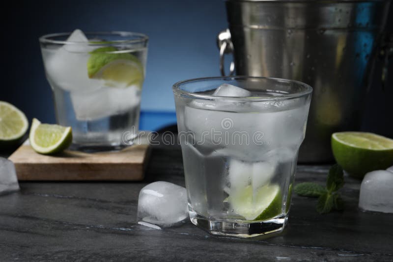 Glasses of Vodka, Lime, Mint and Ice on Black Marble Table Stock Image ...