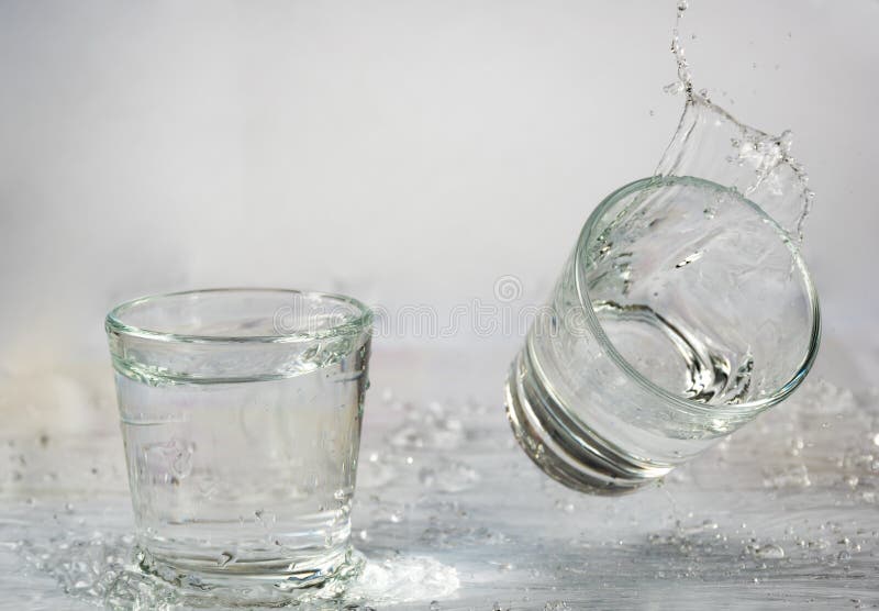 Glasses of Water Falling and Jumping with Splashes and Drops Stock ...
