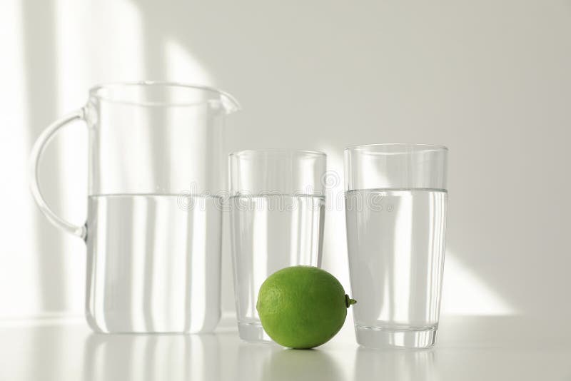 Glassware of Fresh Water and Lime on Table Stock Photo - Image of ...