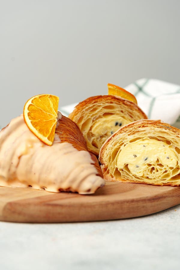 Glazed Croissant with Dried Orange on Wooden Board on Table Stock Image ...