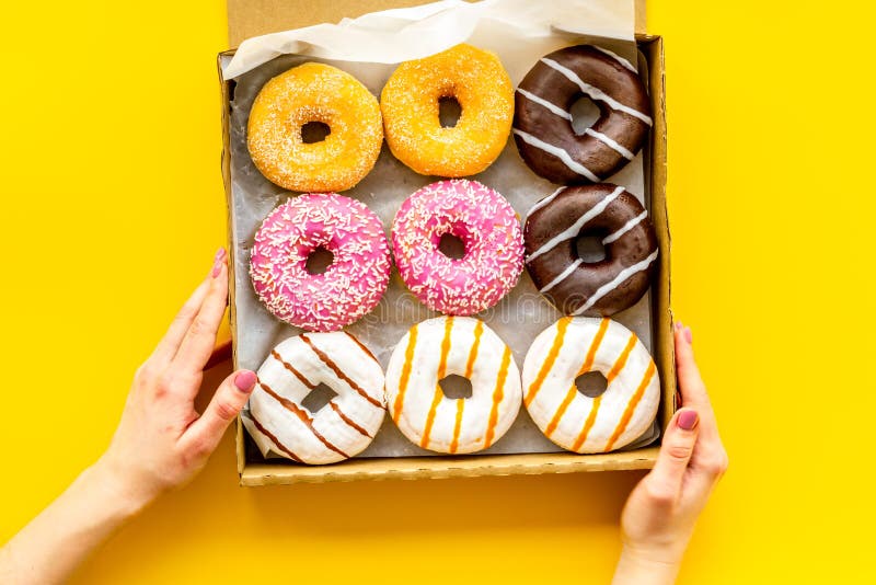 Glazed Decorated Donuts in Box for Sweet Break on Yellow Background ...