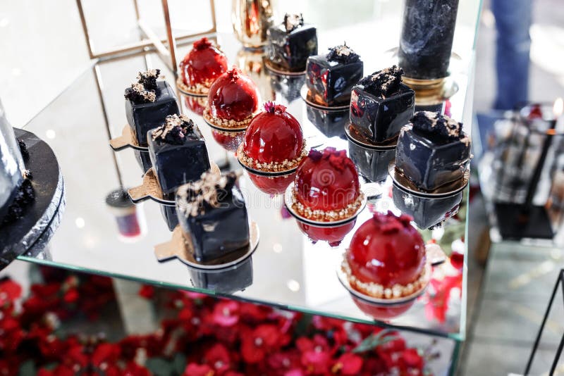 Glazed red and black cakes stock image. Image of dessert - 184587573