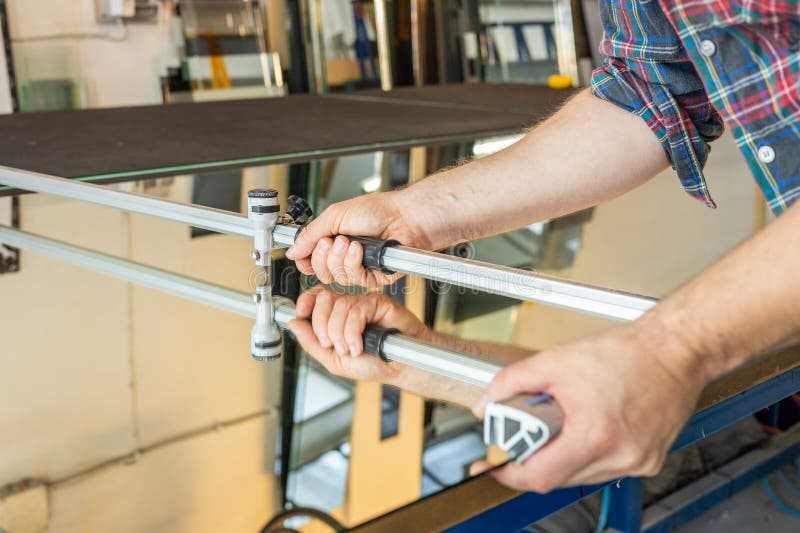 A Glazier Cuts Glass Sheets in a Factory Using a Specialized Hand ...
