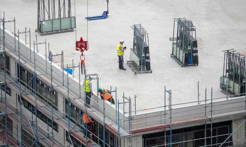 Glazier Installing Windows on a Commercial Building. Stock Photo ...
