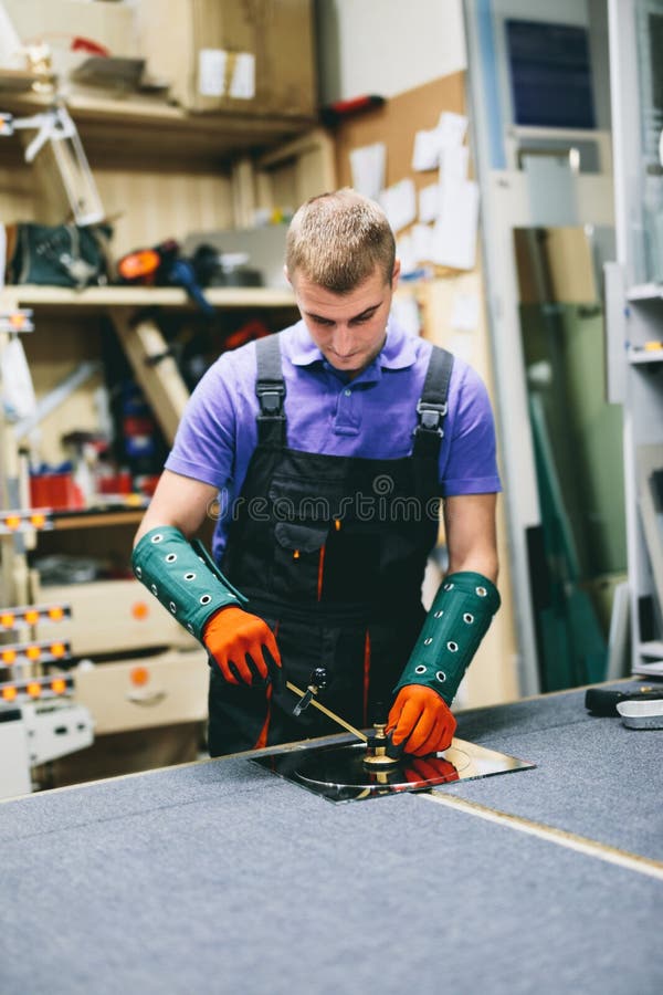 Glazier Worker Cutting Glass with Compass Glass Cutter in a Workshop ...