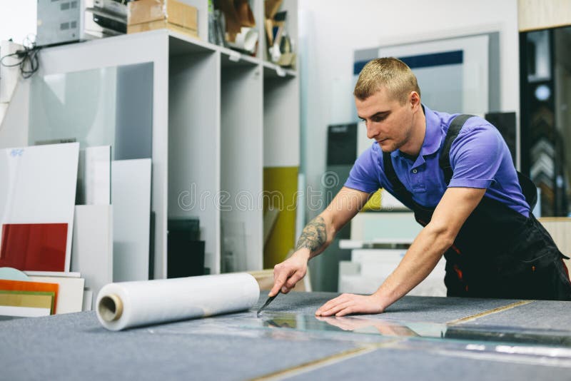 Glazier Worker Cutting Glass with Compass Glass Cutter in a Workshop ...