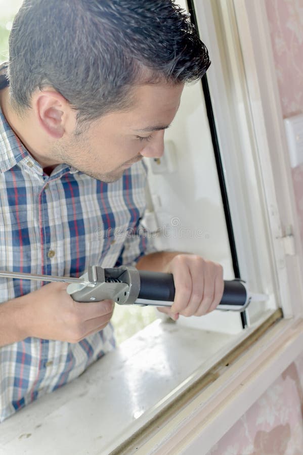 Glazier working on window stock photo. Image of professional - 95597246