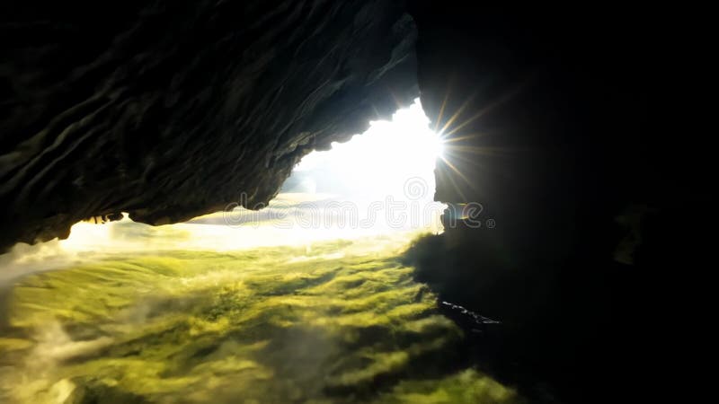 Dark Cave Opening Reveals a Bright Waterfall and Landscape Stock Video ...