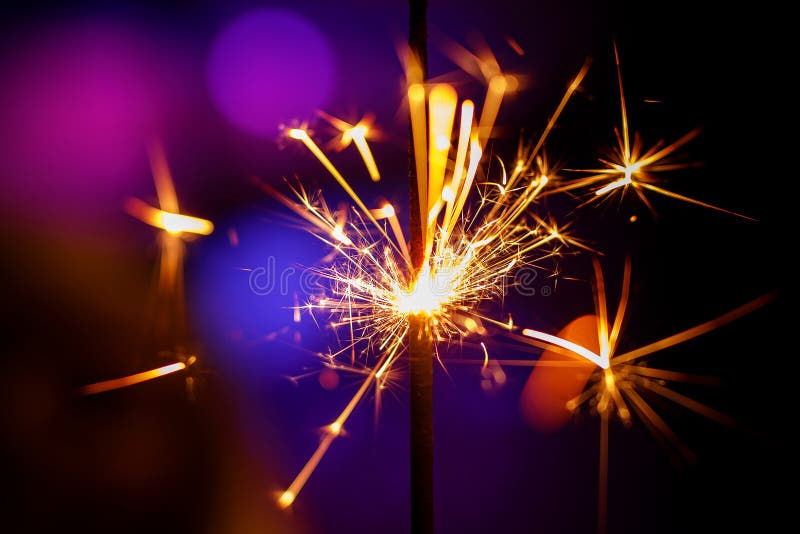 Glittering Burning Sparkler on Purple and Blue Background. Stock Image ...