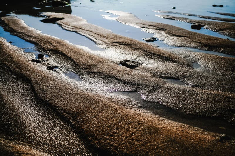 Glittering Wet Sand Patterns at Shoreline during Low Tide Stock Image ...