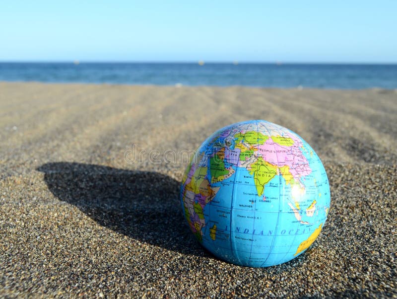 Globe Earth on the Beach stock photo. Image of sand - 244885792