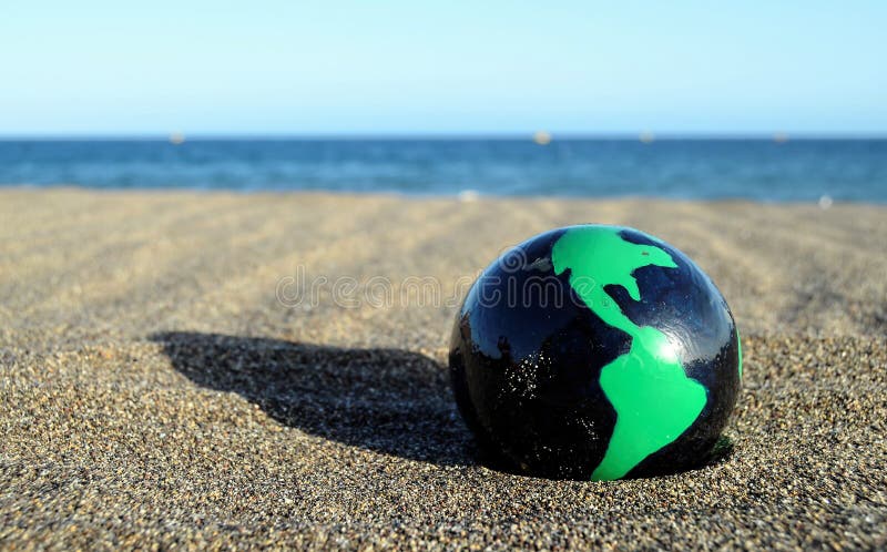 Globe Earth on the Beach stock photo. Image of sand - 215889588