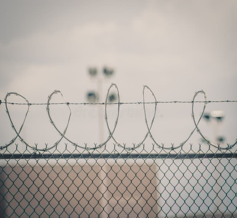 Gloomy prison barbed wire stock photo. Image of security - 124011786