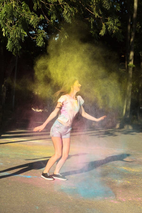 Glorious Brunette Girl Jumping with Exploding Pink and Yellow H Stock ...