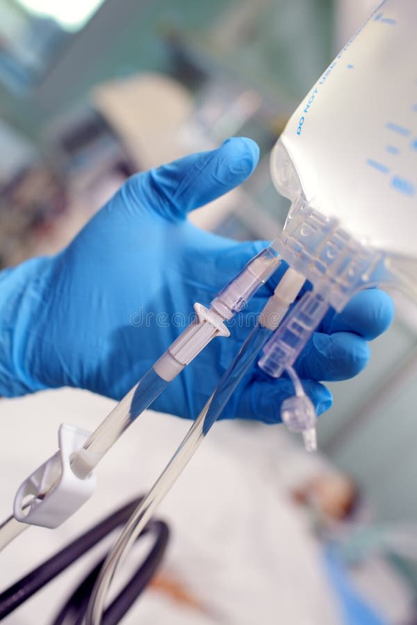 Gloved Hand Holding Intravenous Drip in the Patient Ward Stock Image ... Gloved Hand Holding Intravenous Drip in the Patient Ward Stock Image ...