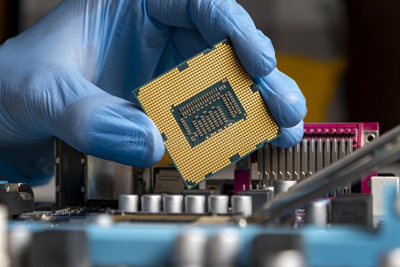 Gloved Hand Holding Microprocessor Near the Motherboard. Stock Photo ...