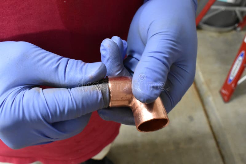 Gloved Hands Sanding Copper Elbow Water Pipe Fitting in Garage Stock ...