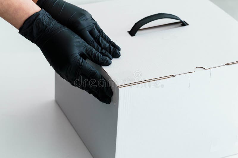 Gloved Hands Securing White Cardboard Box for Safe Delivery and ...