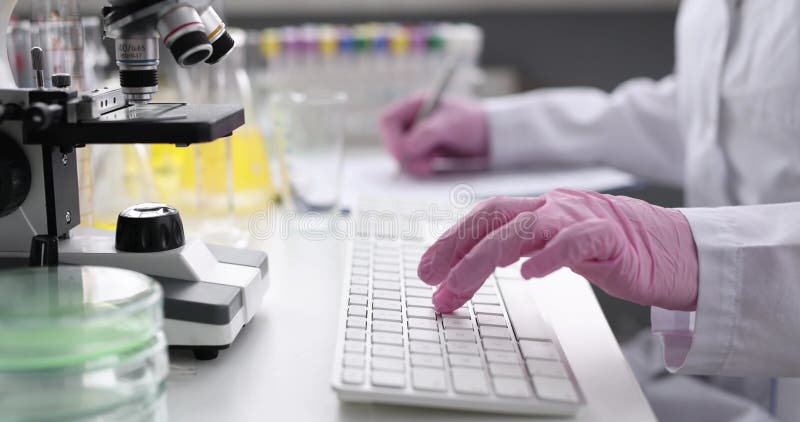 Gloved Hands Typing on Computer Keyboard in Laboratory Stock Video ...