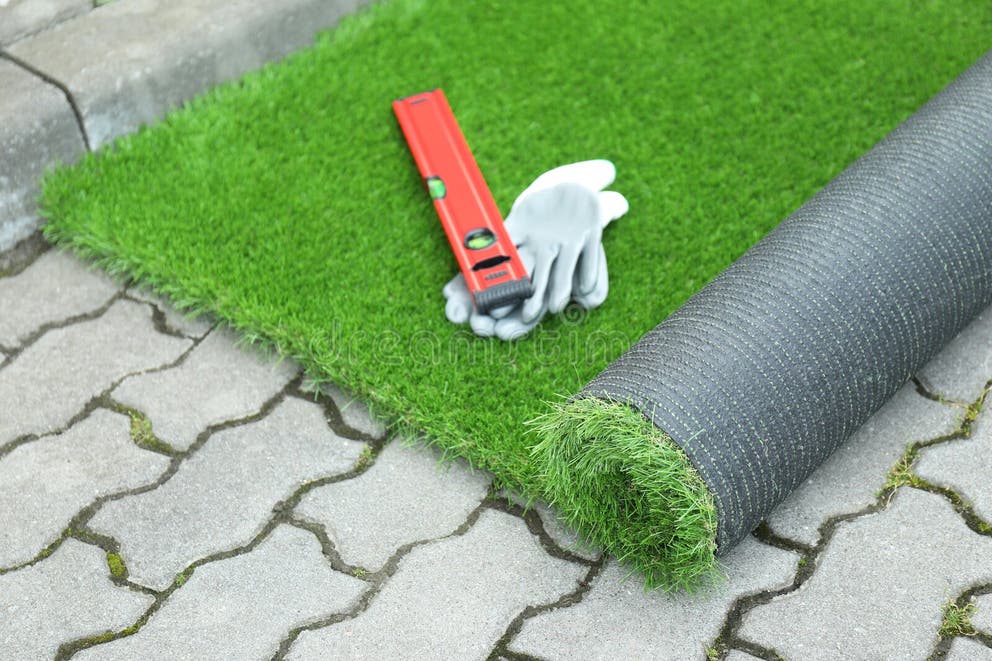 Gloves, Level Tool and Roll of Artificial Turf Outdoors Stock Image ...