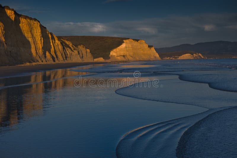 Glow Of Sunset On Beach Cliffs Stock Photo - Image of dusk, natural ...