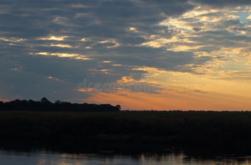 GLOW of SUNSET OVER AFRICAN BUSH and KAVANGO RIVER Stock Photo - Image ...