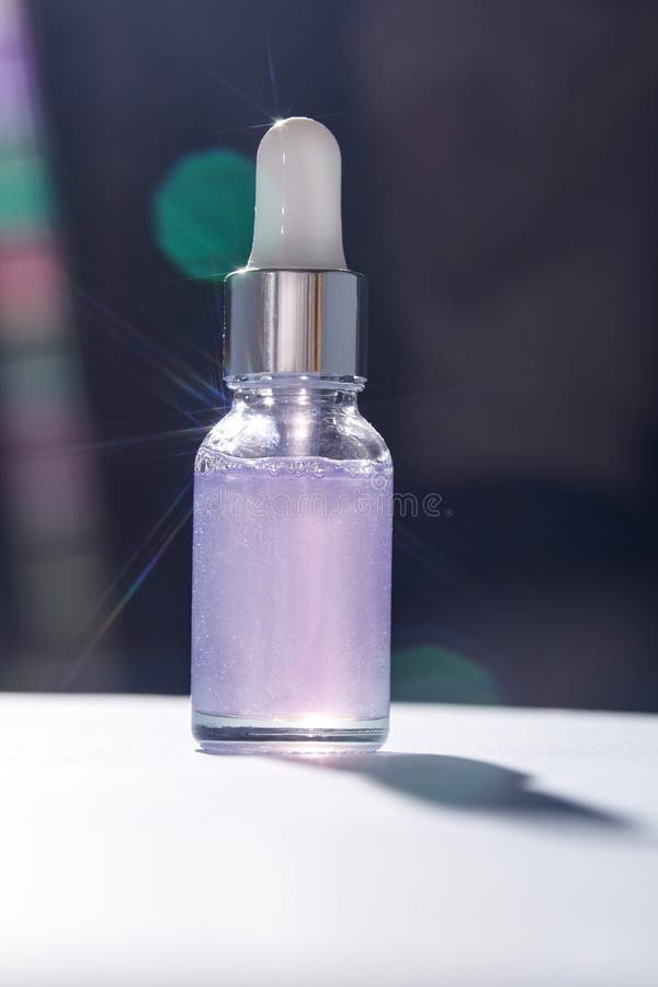 Glowing Bottle of Purple Liquid Serum with Dropper Lid and Bokeh Light ...