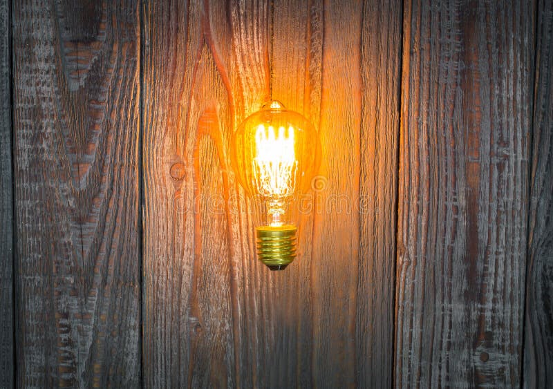Glowing bulb on the wood stock photo. Image of power - 54090368