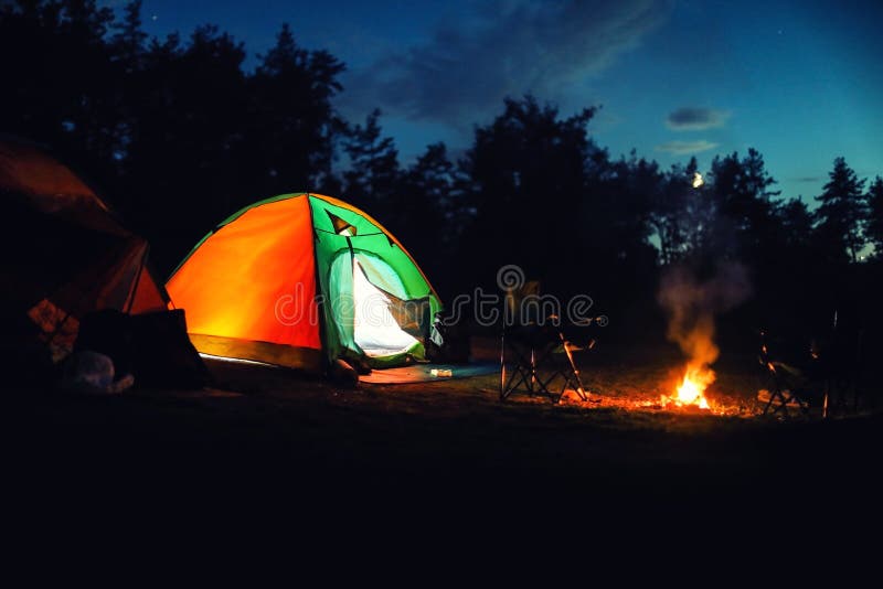 Glowing Camping Tent Near Bonfire in Wilderness Stock Photo - Image of ...