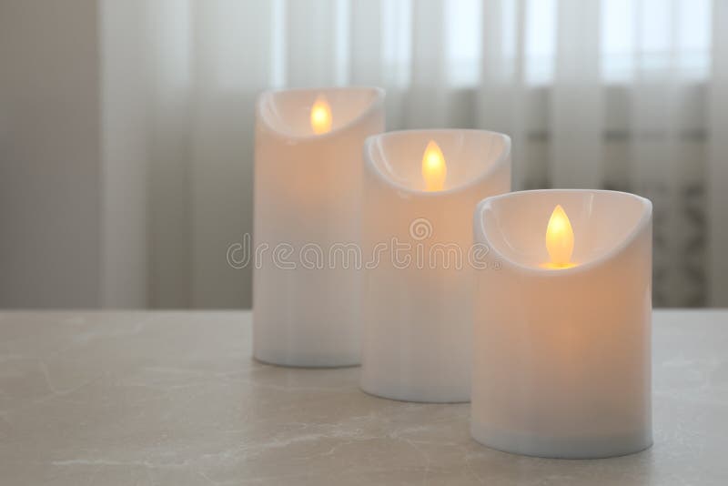 Glowing Decorative LED Candles on Grey Table. Space for Text Stock ...