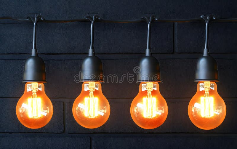 Glowing Edison Bulbs String Lights on Dark Brick Royalty Free Image ...