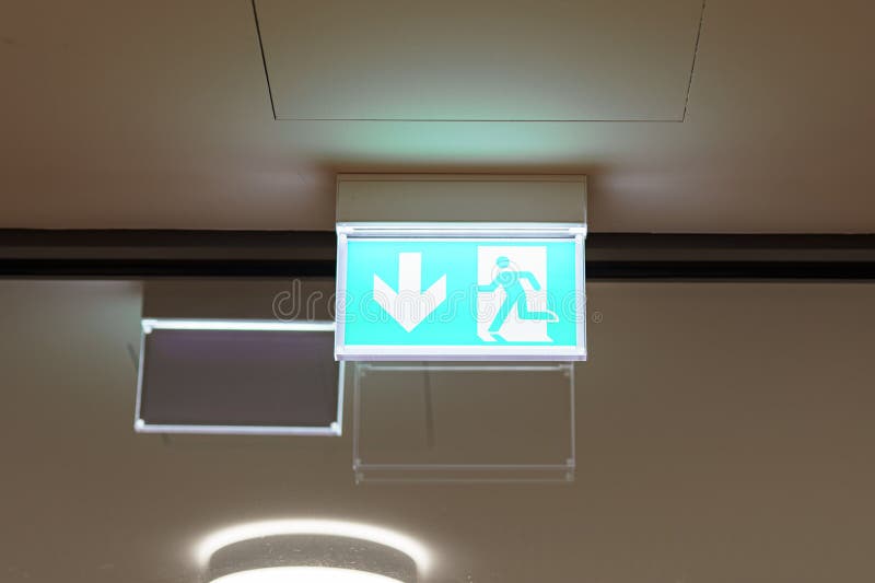 Glowing Exit Sign on the Ceiling in the Corridor Stock Image - Image of ...