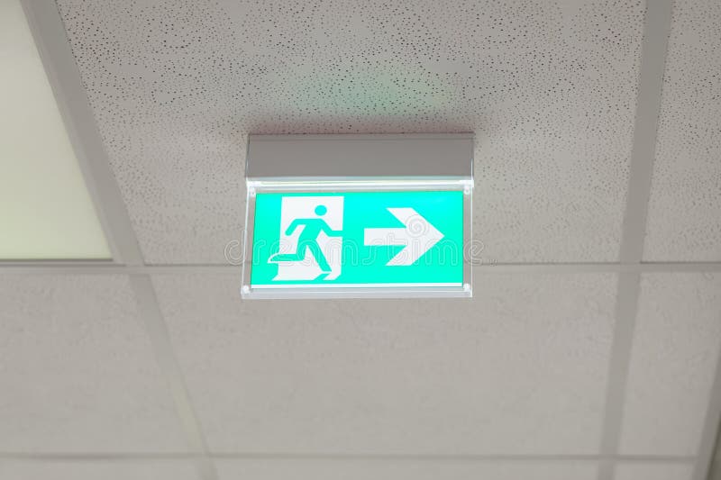 Glowing Exit Sign on the Ceiling in the Corridor Stock Photo - Image of ...