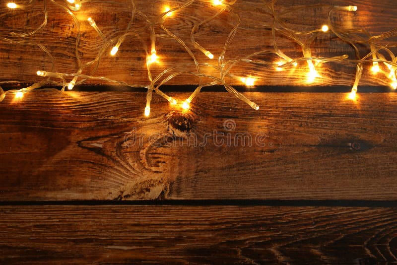 Glowing Festive Lights on Wooden Background, Top View. Space for Text ...