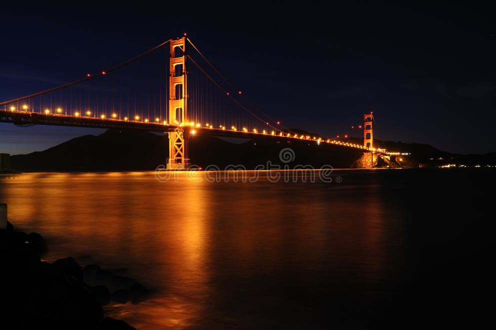 Glowing Golden Gate Bridge from Fort Point Stock Image - Image of ...